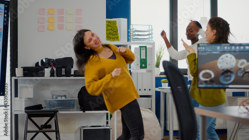 Happy diverse businesswomen dancing in company office celebrating ...