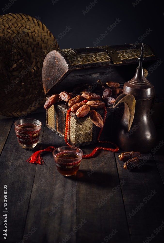 Bunch of Arabic dates popping out from an antique wooden trunk with ...