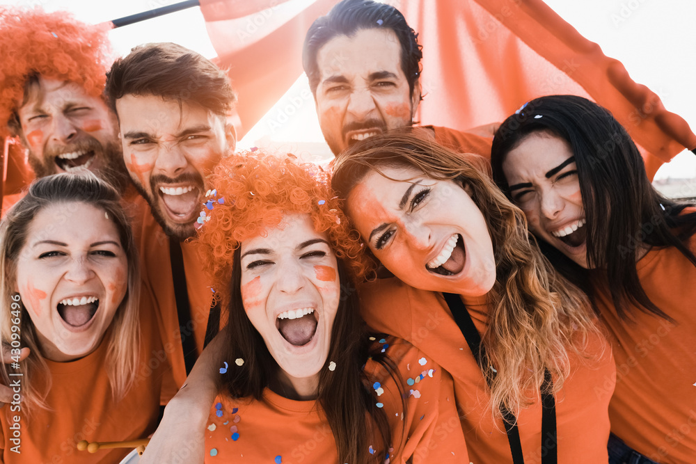 Orange sport fans screaming while supporting their team out of the ...