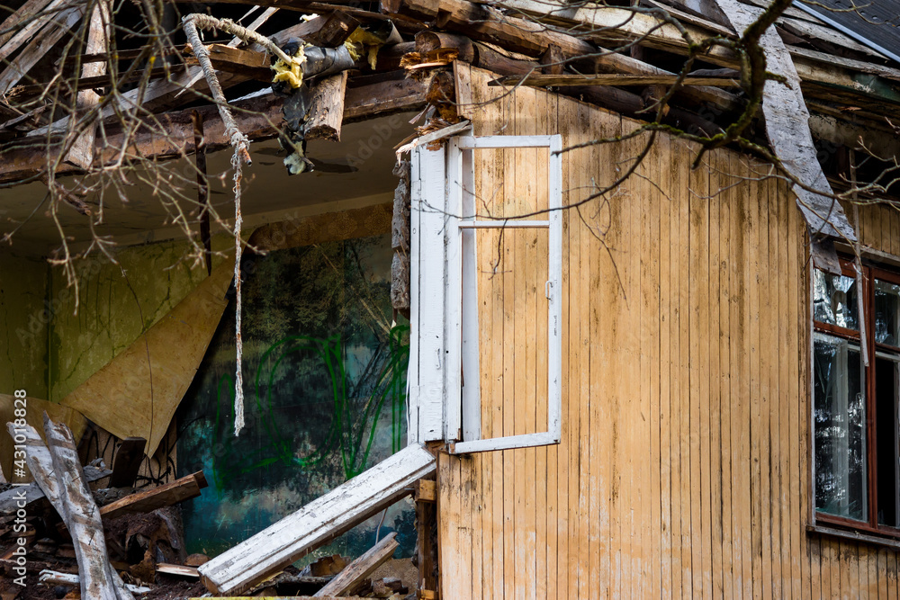 Demolition of an old two-story wooden house. Half destroyed building ...