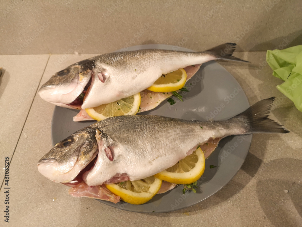 grilled sead fish sea bream fish cleaned and seasoned with lemon ready ...
