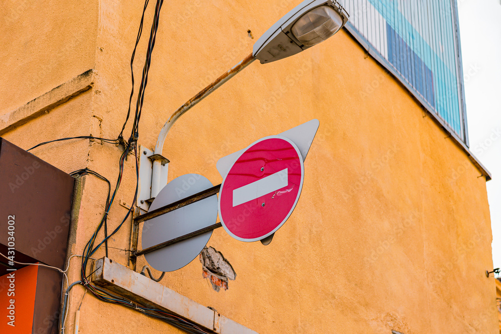 Circular do not enter prohibition traffic sign installed on the yellow ...