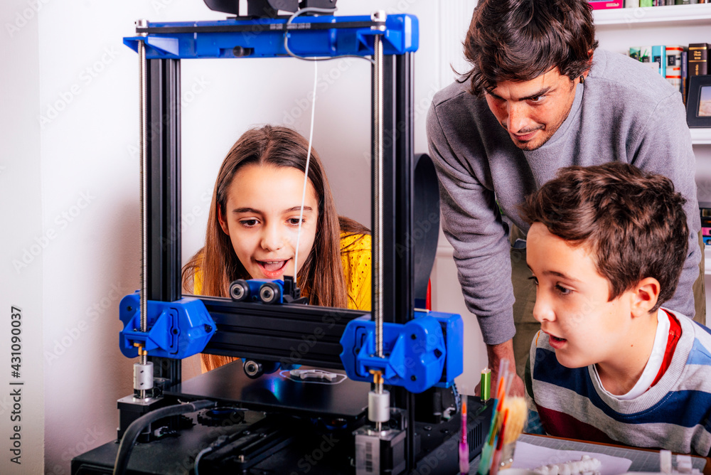 Happy children learning to 3D print with a young adult Stock Photo ...