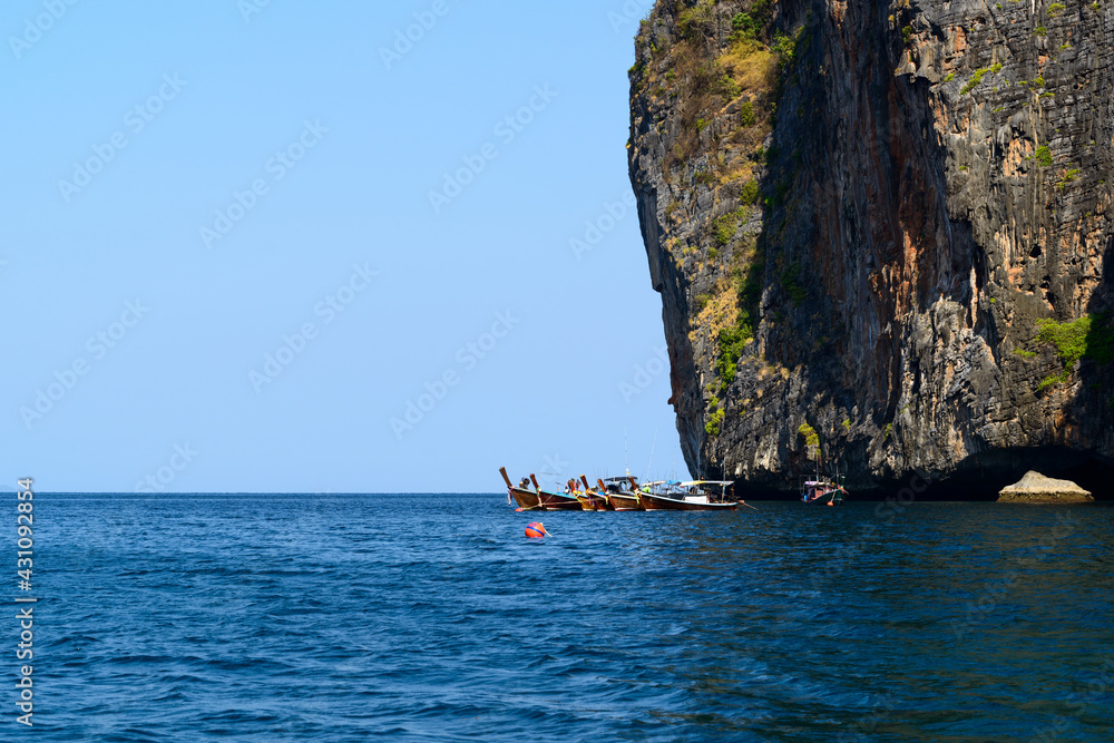 Thai traditional long-tailed boats moored in front of the western part ...