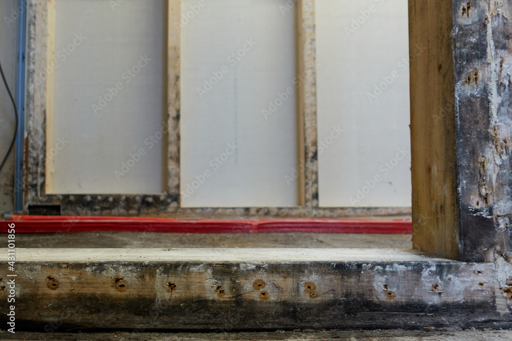 Wooden beams with mold infestation. Red water pipes were exposed after ...