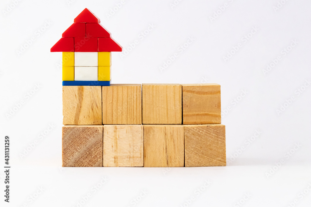 Eight wooden blocks in two rows above each other and a Bricks house on ...