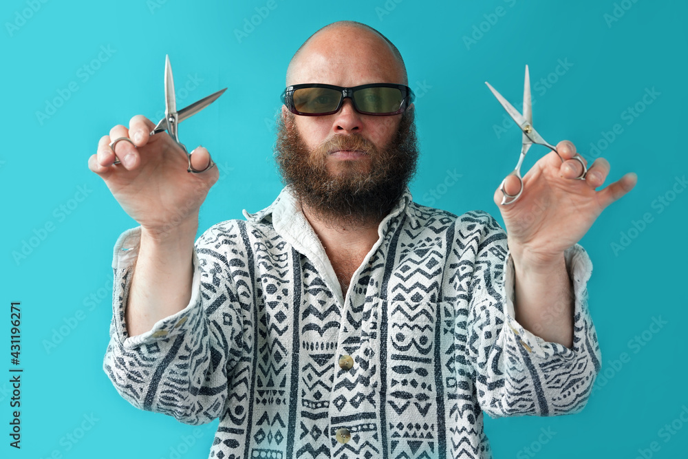 Tailor. A man with a beard holds a scissor in his hands. Guy with ...