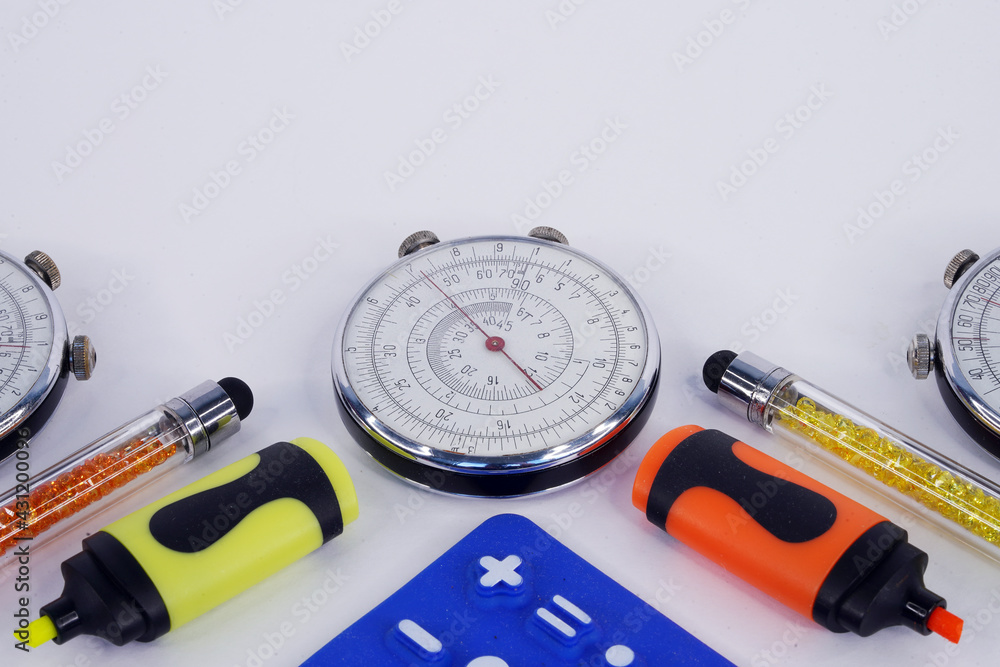 Logarithmic ruler closeup and colorful pencils on a white background ...