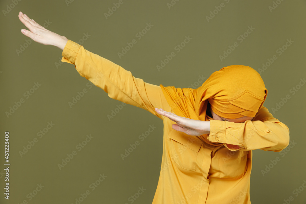 Young arabian asian muslim woman in abaya hijab yellow clothes do dab ...