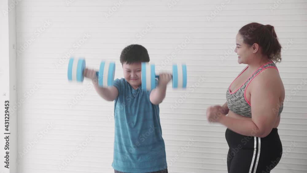 Asian family mother training with son fat exercise with dumbbell and at ...