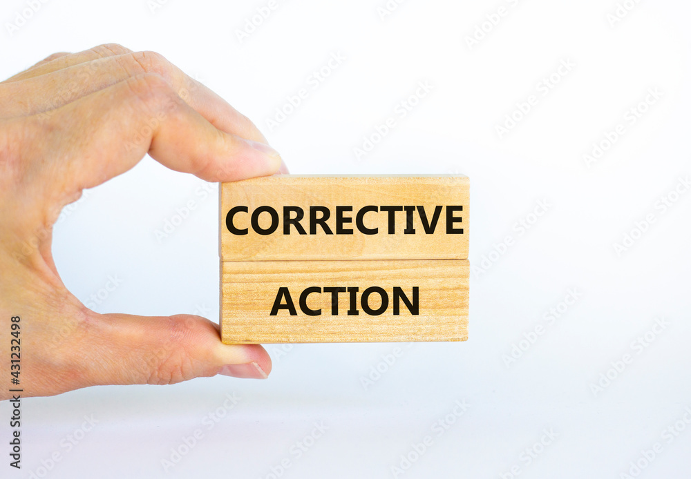 Corrective action symbol. Wooden blocks with words 'Corrective action ...
