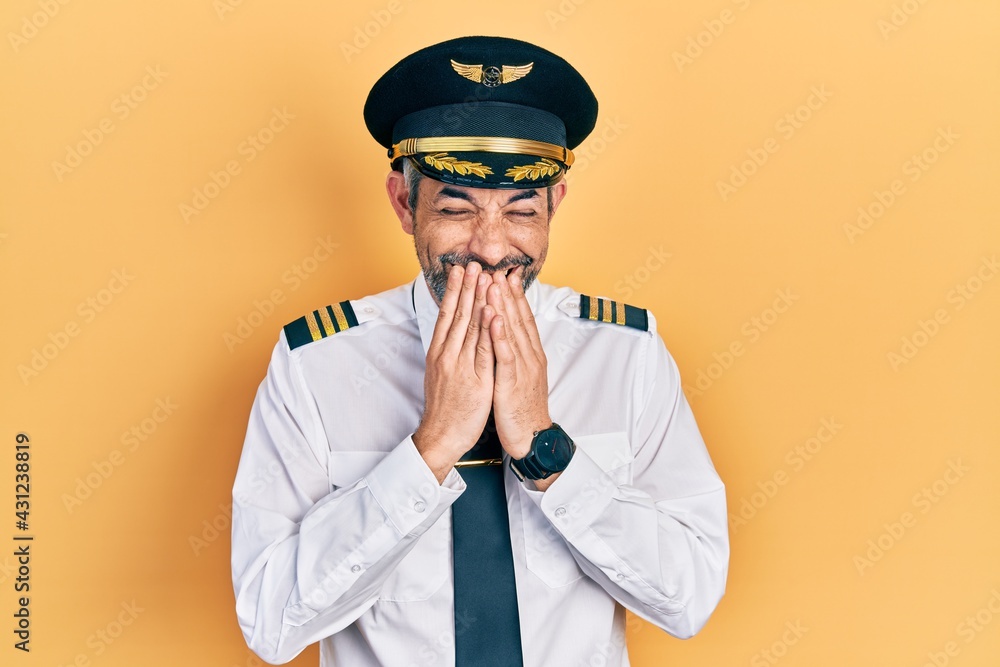 Handsome middle age man with grey hair wearing airplane pilot uniform ...
