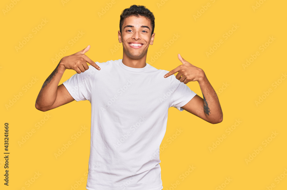 Young handsome african american man wearing casual white tshirt looking ...