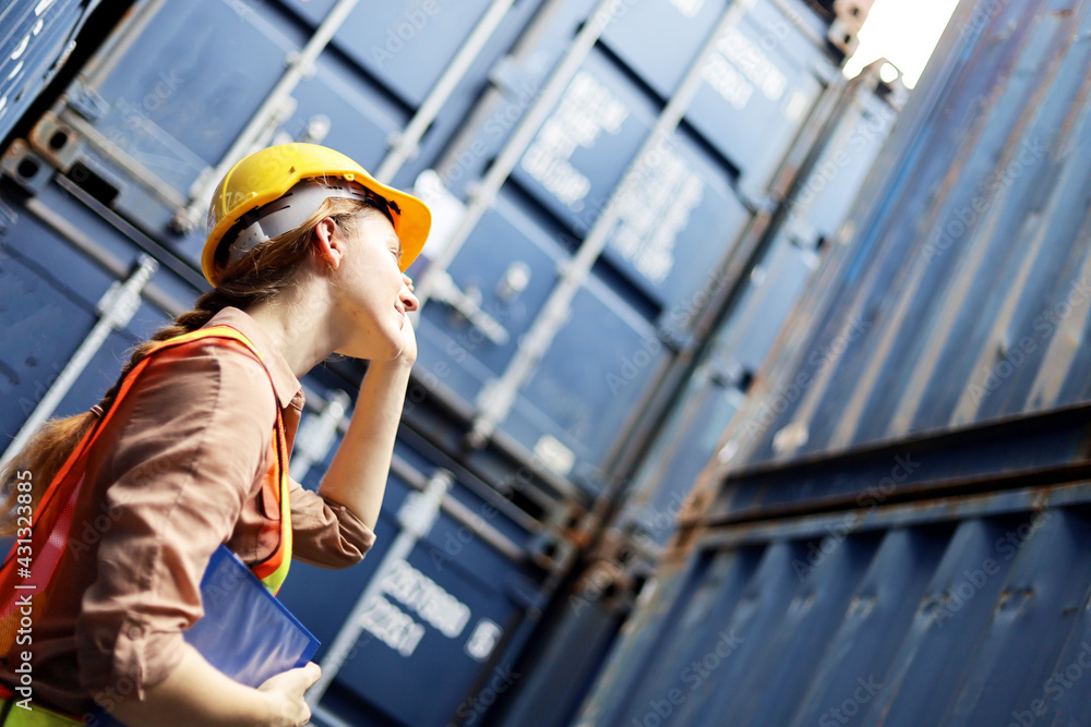 Young Engineers standing in the shipping yard tracking the cargo ...