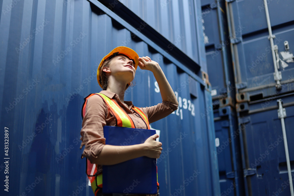 Young Engineers standing in the shipping yard tracking the cargo ...
