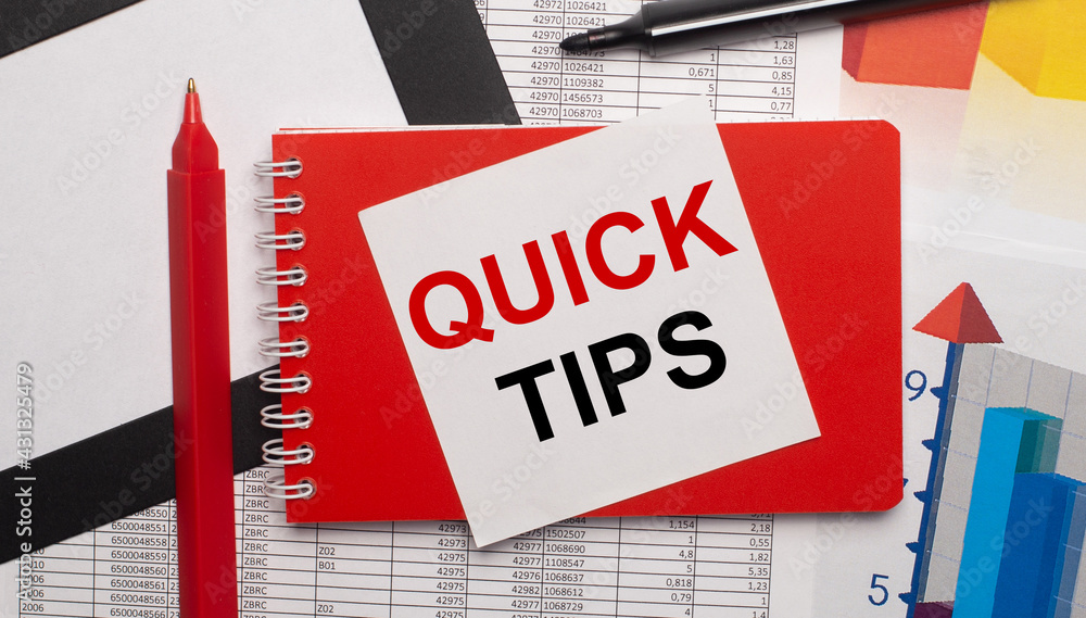 On the desktop are reports, charts, a red pen, a black marker, a red ...