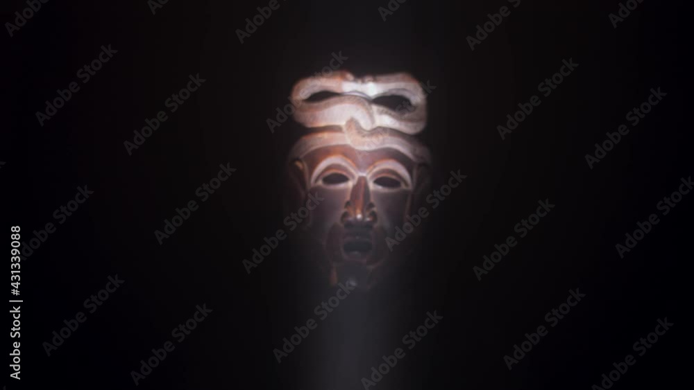 Creepy, masked cultist standing in a dark room. Scary horror scene ...