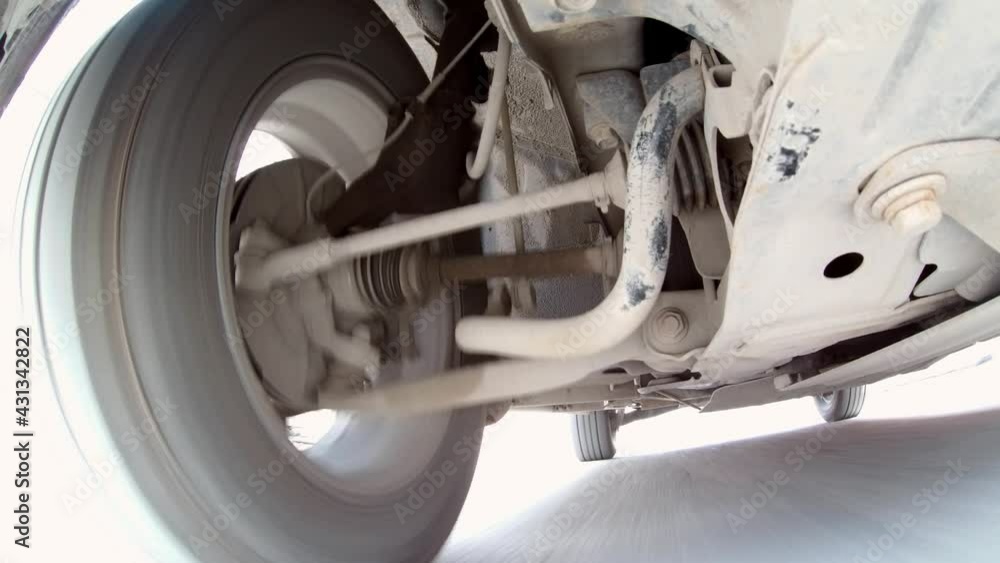 SUV driving on a road. Camera from below the car. Work vehicle ...
