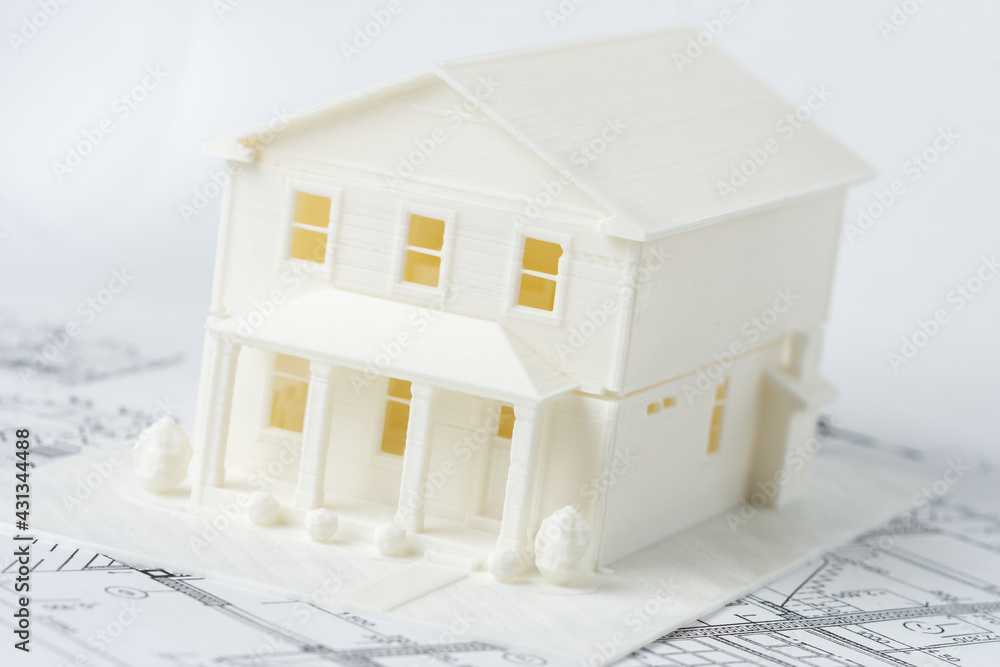 Model of the family house printed on a 3D printer with white filament ...