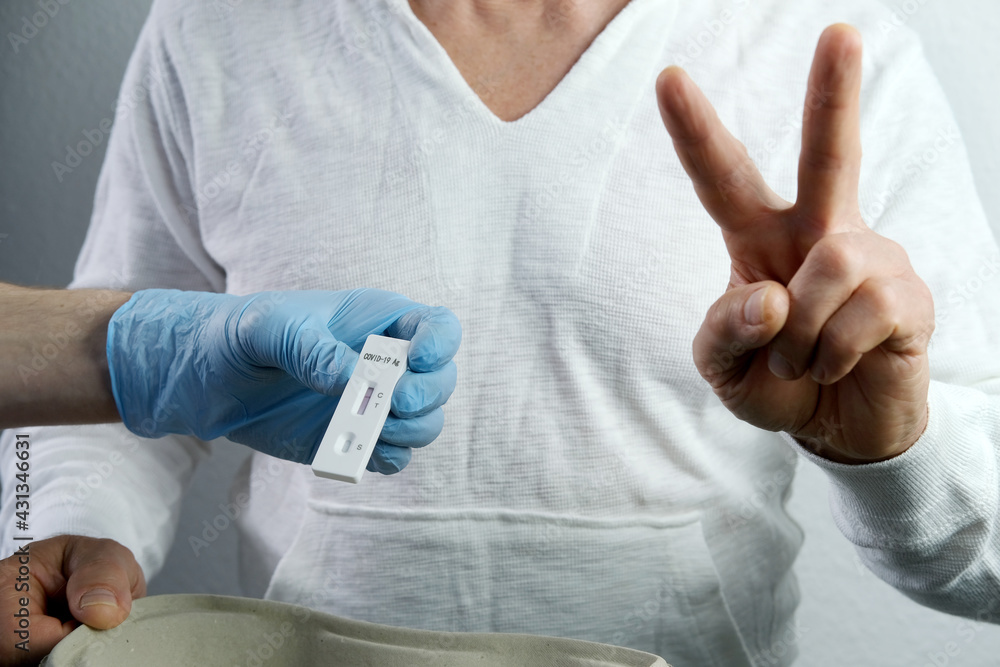close-up of a male medic's hand holding a test cassette, medical ...