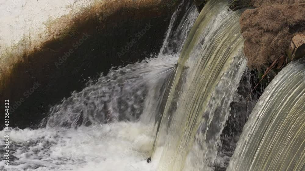 Water sluice. Artificial waterfall in the dam. The flow of water in the ...