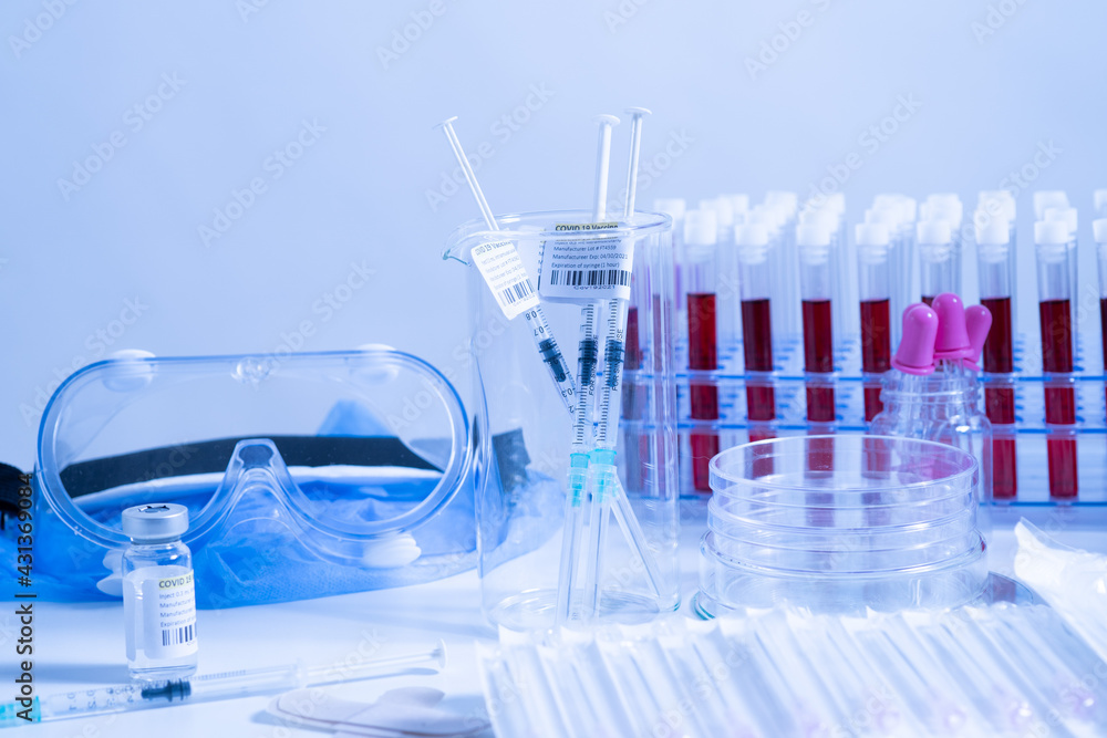 Vaccine vials and syringes containing COVID 19 cure. Ready to ...