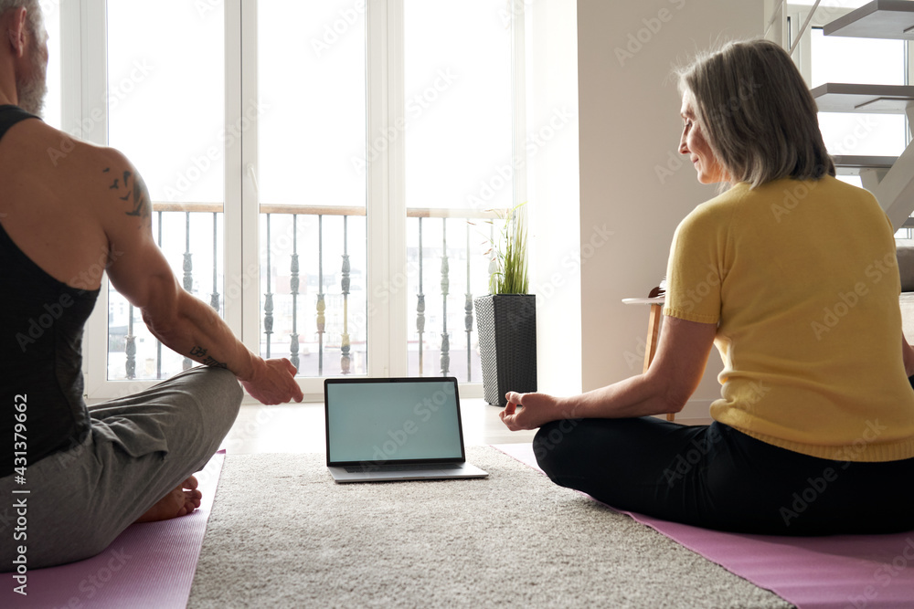 Foto Stock Fit senior older couple watching online yoga class doing ...