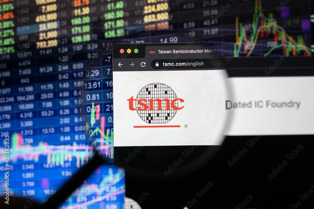 TSMC company logo on a website with blurry stock market developments in ...