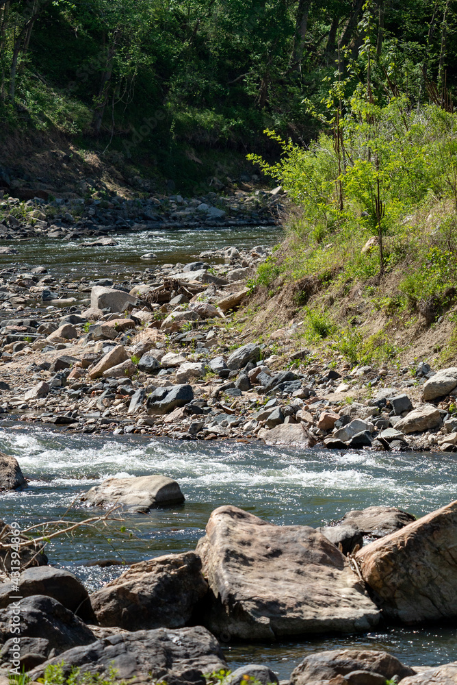 A natural bend in a river with stoney bed, the fast running water ...