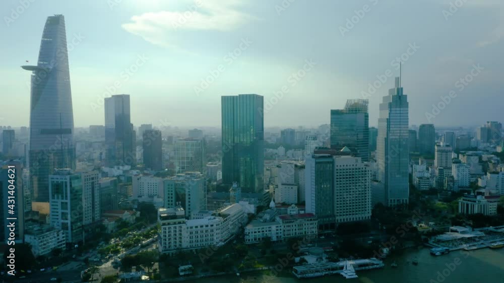 Saigon river waterfront with long afternoon shadows from the Ho Chi ...