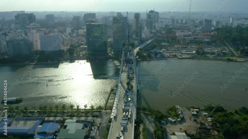 Saigon river waterfront with long afternoon shadows from the Ho Chi ...