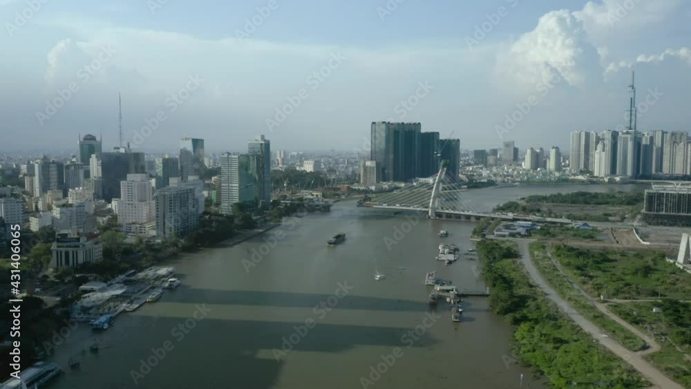 Saigon river waterfront with long afternoon shadows from the Ho Chi ...