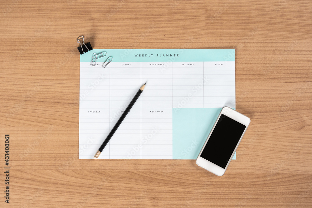 Blank weekly planner notice block on a desk in an office. Empty ...