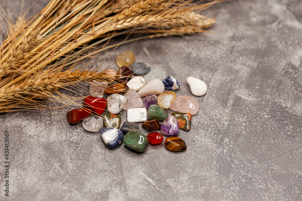Row of multicoloured healing crystals on grey background. Various ...
