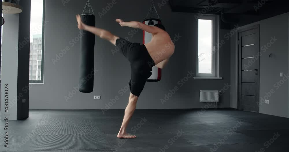Mixed martial art fighter does shadow boxing and trains at fighter club ...