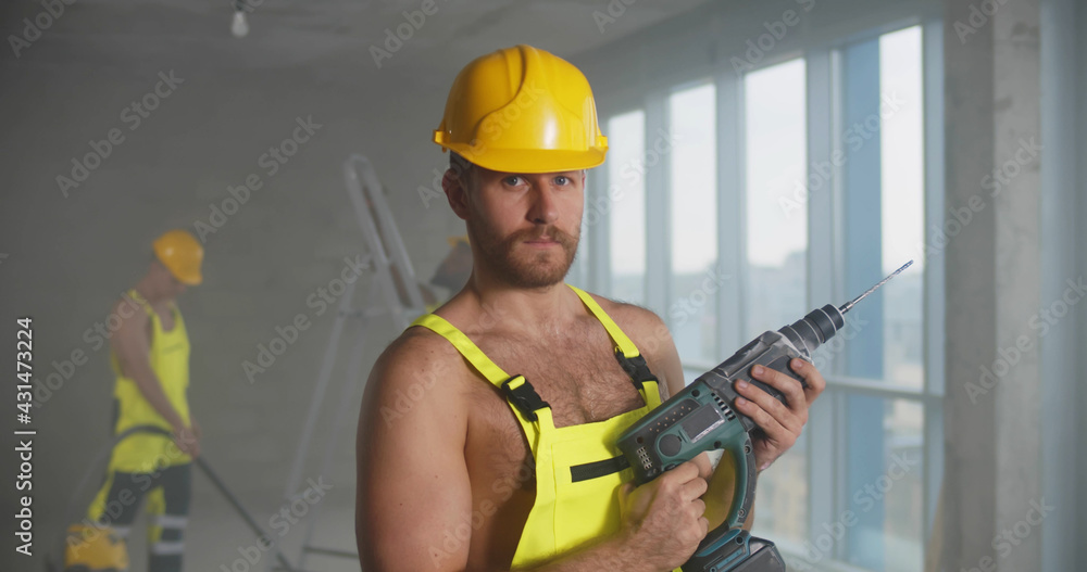 Young handsome male construction worker posing seductively shirtless ...
