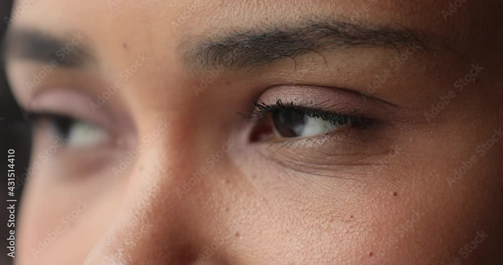 African woman looking into distance close up face part and eye view ...