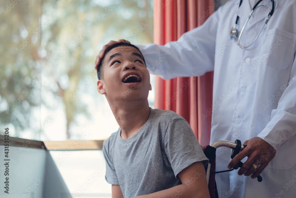 The hands of kind doctor and disabled child in wheelchair, Lifestyle in ...