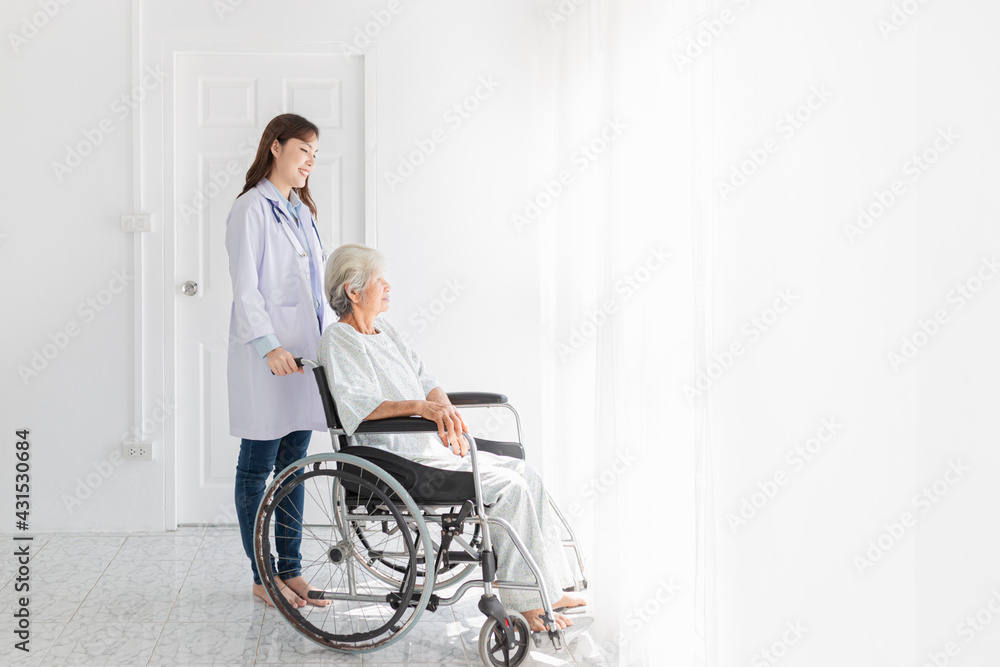 close up patient, Asian doctor drive a wheelchair of old patient ...