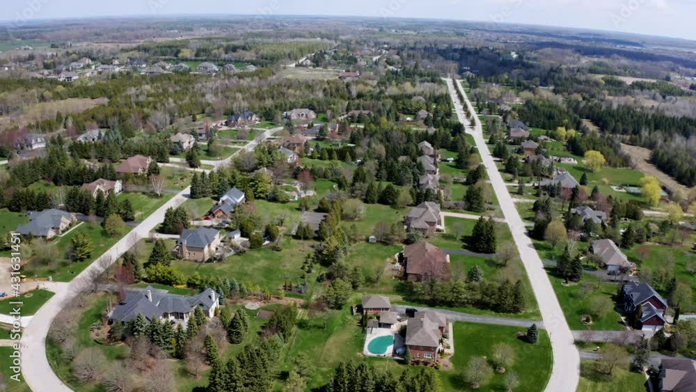 A drone shot above an estate home neighborhood in Puslinch, Ontario ...