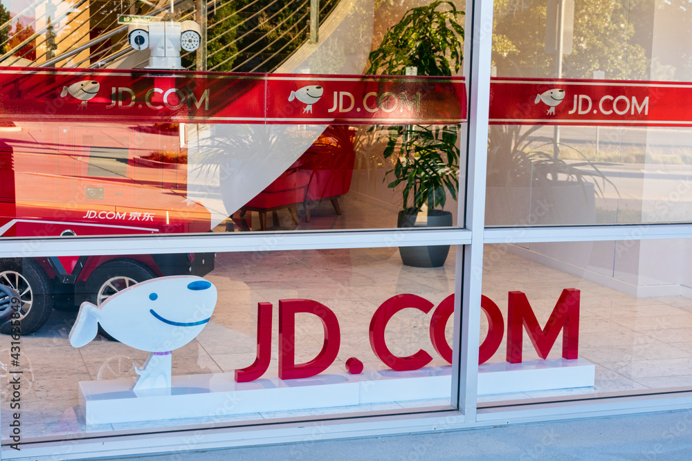 Logo and dog mascot of Chinese JD.com e-commerce company on the glass ...
