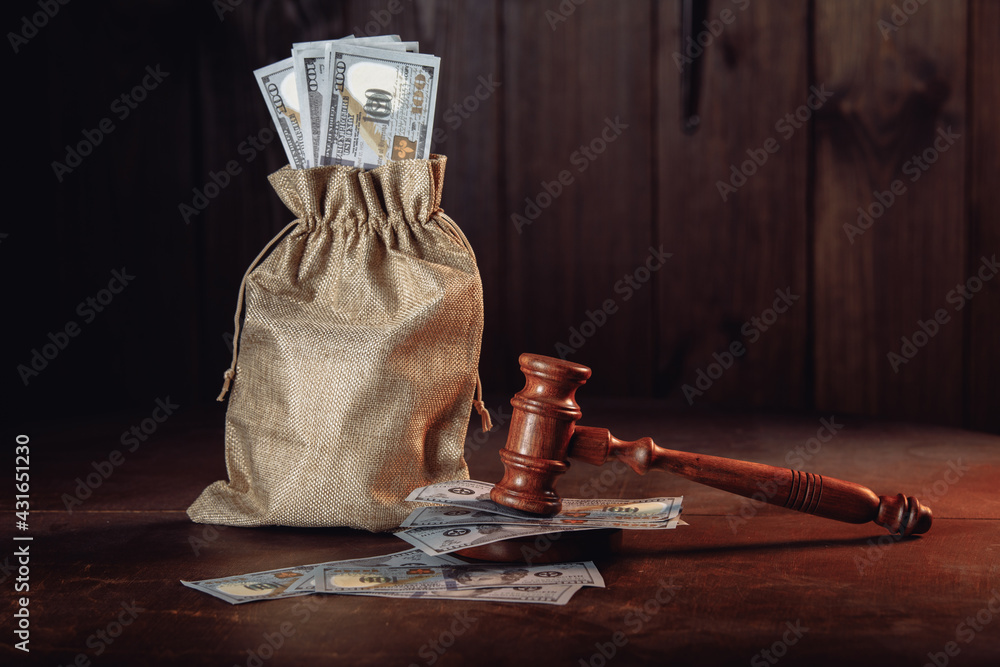 Money bag with dollar banknotes and judge's gavel. Litigation, dispute ...