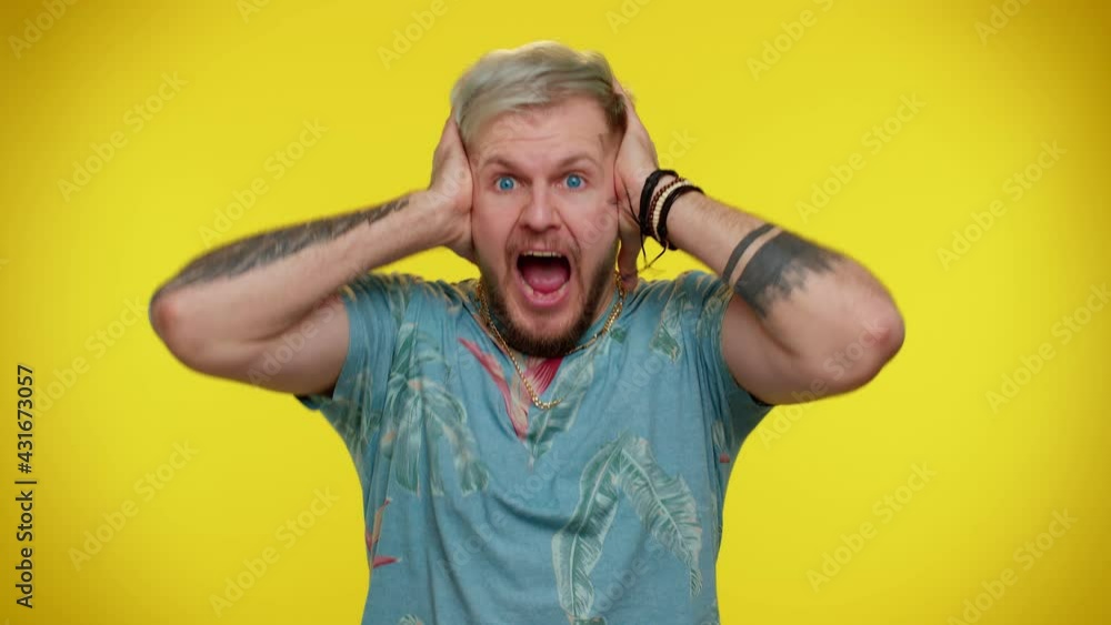 Bearded adult guy scared fearful, covering ears with hands, closing ...