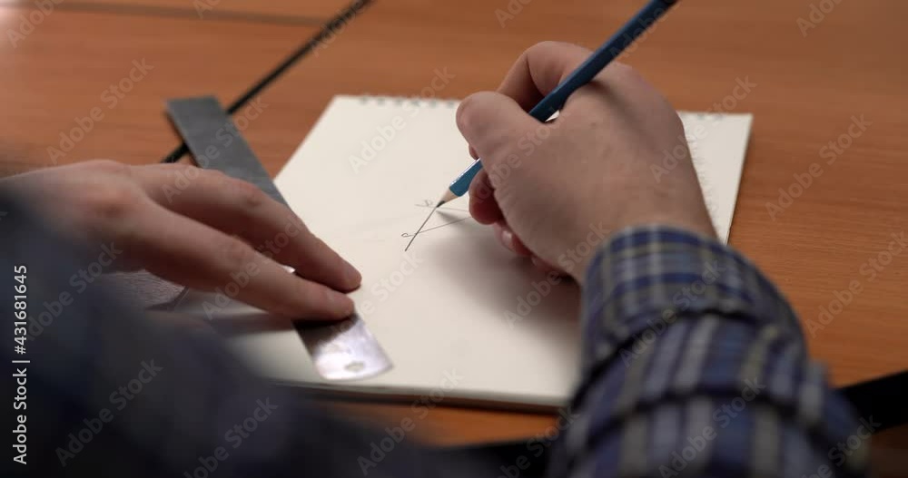 The artist drawing a flat line with a black pencil. Artists hands ...