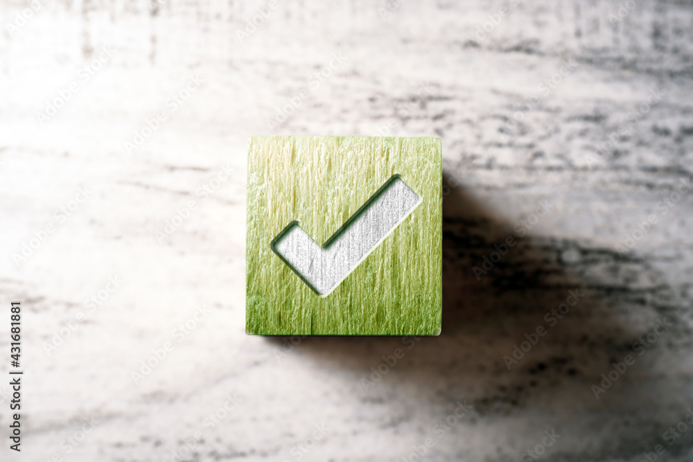 Check Mark On A Green Wooden Checkbox Block On A Table Stock Photo ...