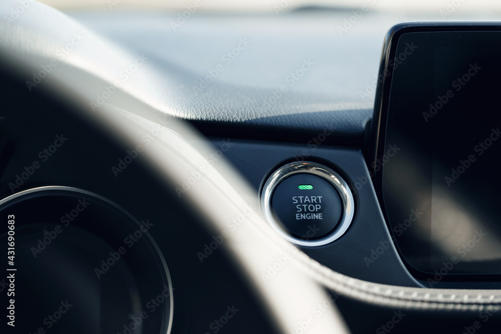 Car Start-Stop Engine Button of a modern car in the interior of the ...
