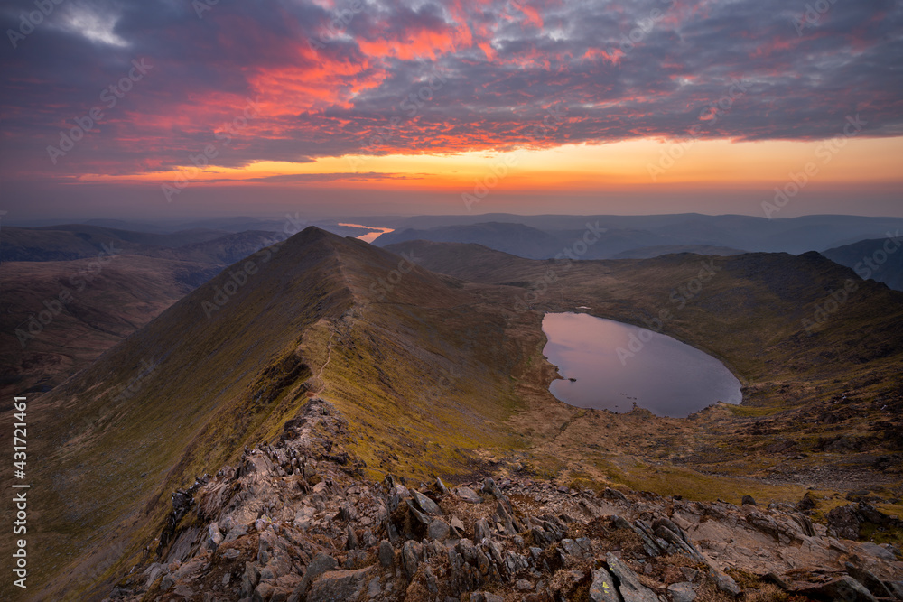 Breathtaking sunrise at the summit of Helvellyn; one of the Lake ...