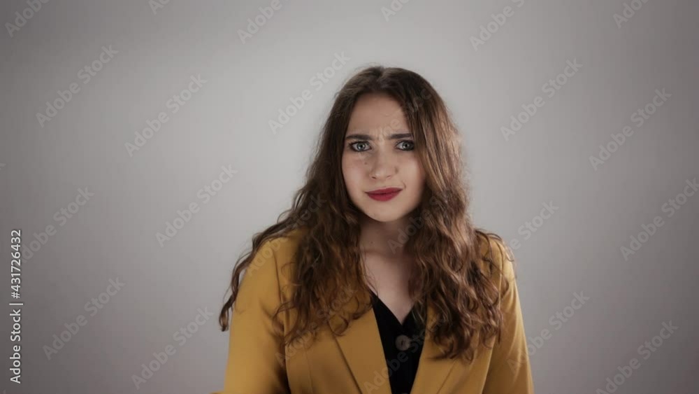 Confused woman is moving her hand in front and frowning in slow motion ...