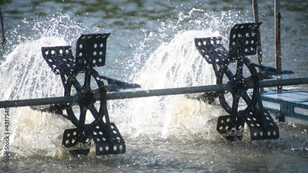 A water turbine used to rotate the water in the aquaculture pond with a ...