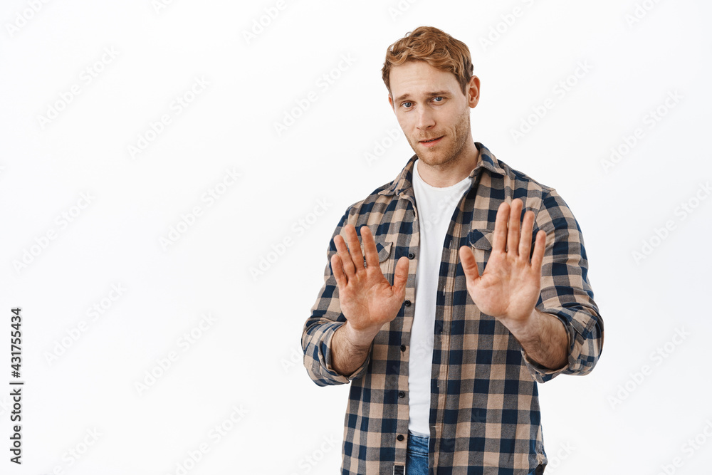 No thank you. Young redhead man shaking hands to refuse, rejecting ...